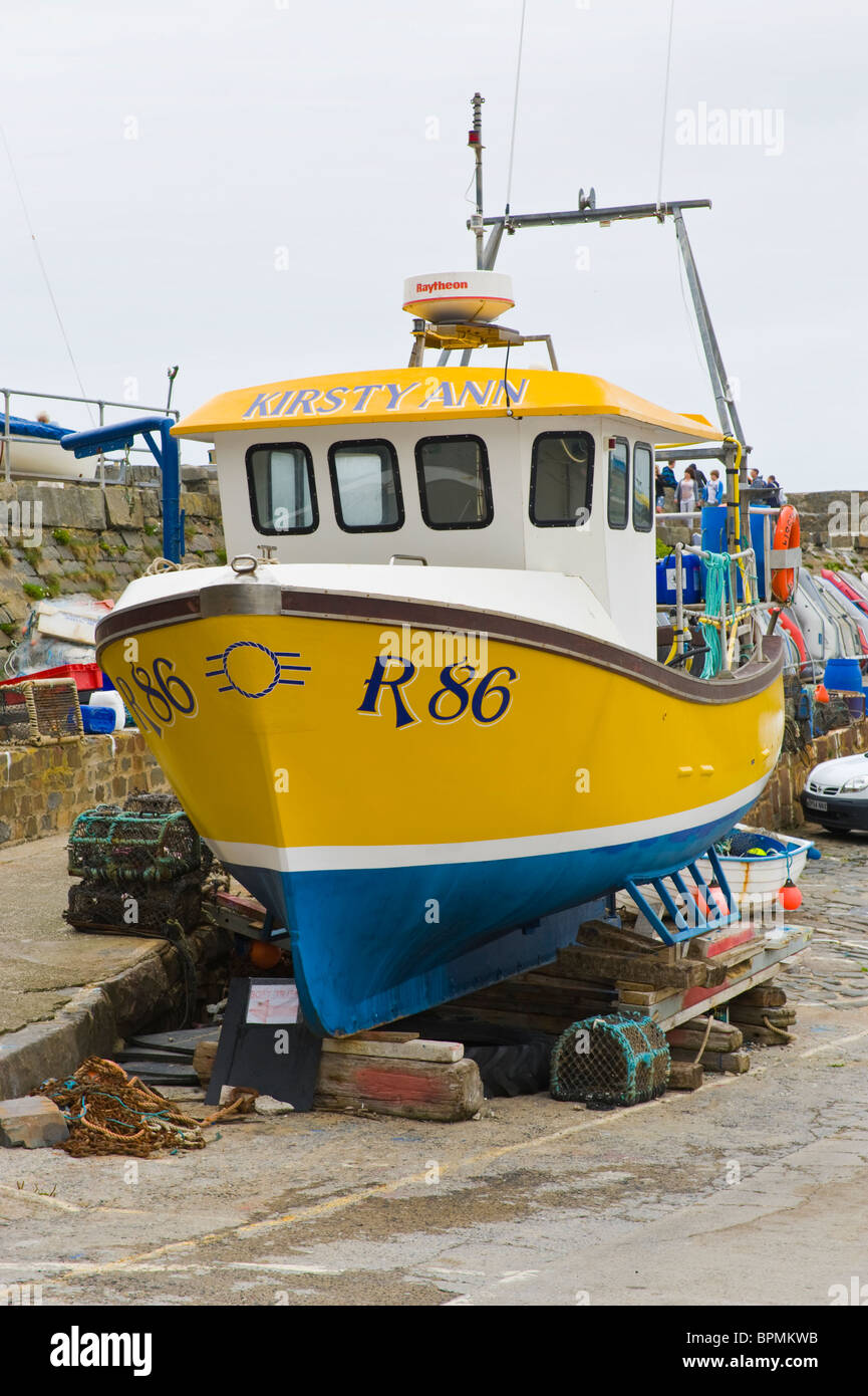 Local fishing boat on harbour slipway for repairs the coastal town of ...