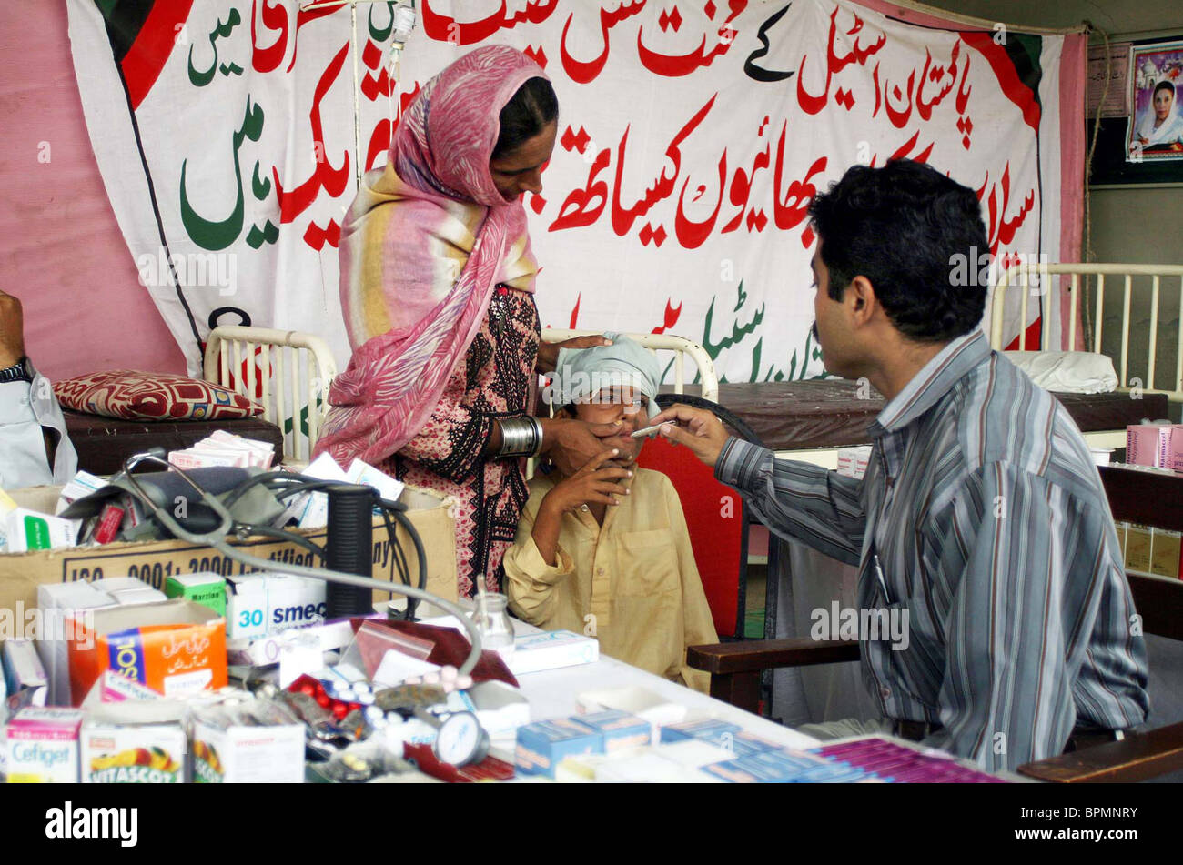 Doctor examines patients at flood affectees relief camp established at ...