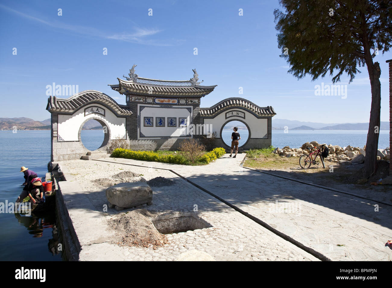 Moon gate at Erhai lake, traditional chinese architecture, tourist with ...