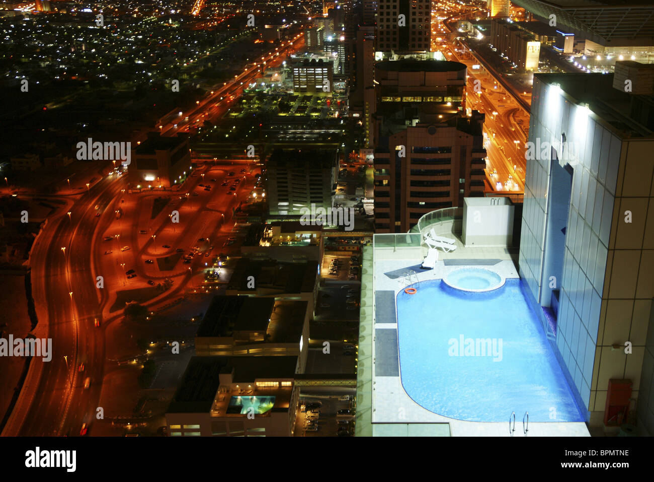Illuminated swimming pool on a high rise building, Dubai, UAE, United ...