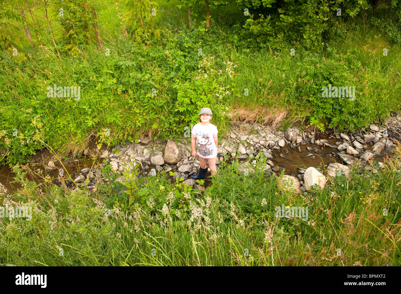 Young girl playing in stream at camp site FULLY MODEL RELEASED Stock ...