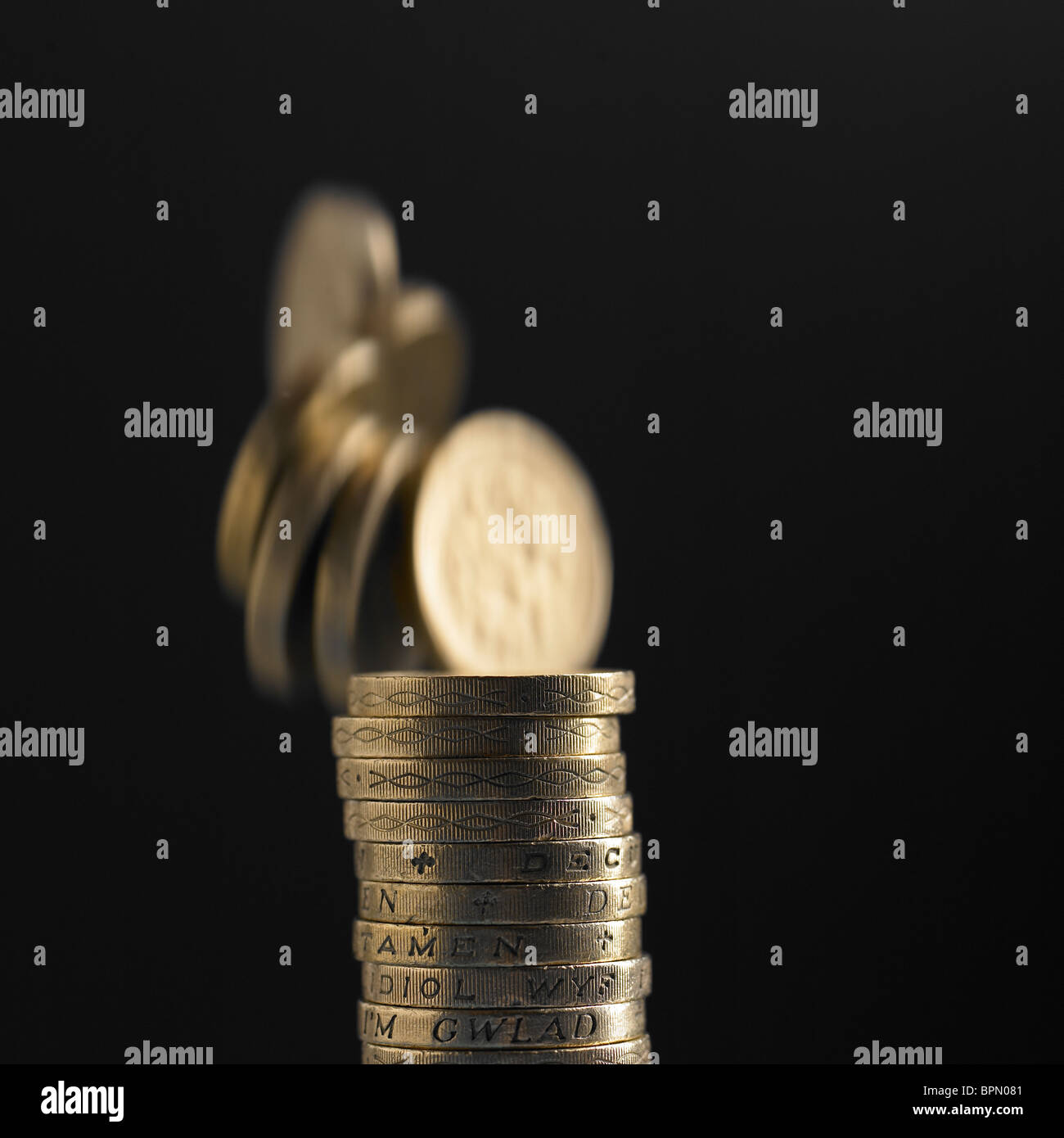 Pound Coins Falling against A Black Background Stock Photo - Alamy