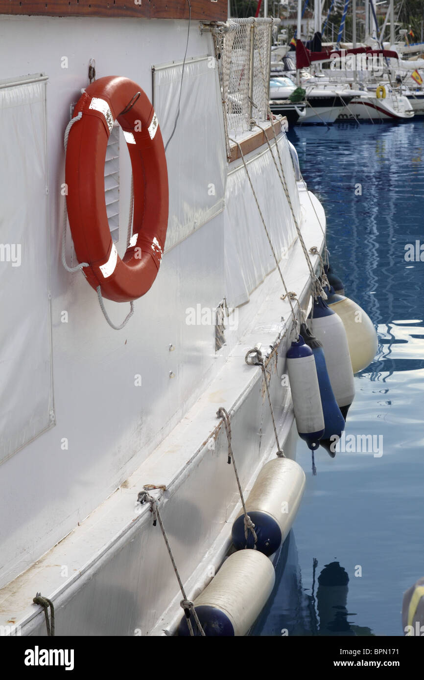 white boat side fender and round lifesaver buoy Stock Photo - Alamy