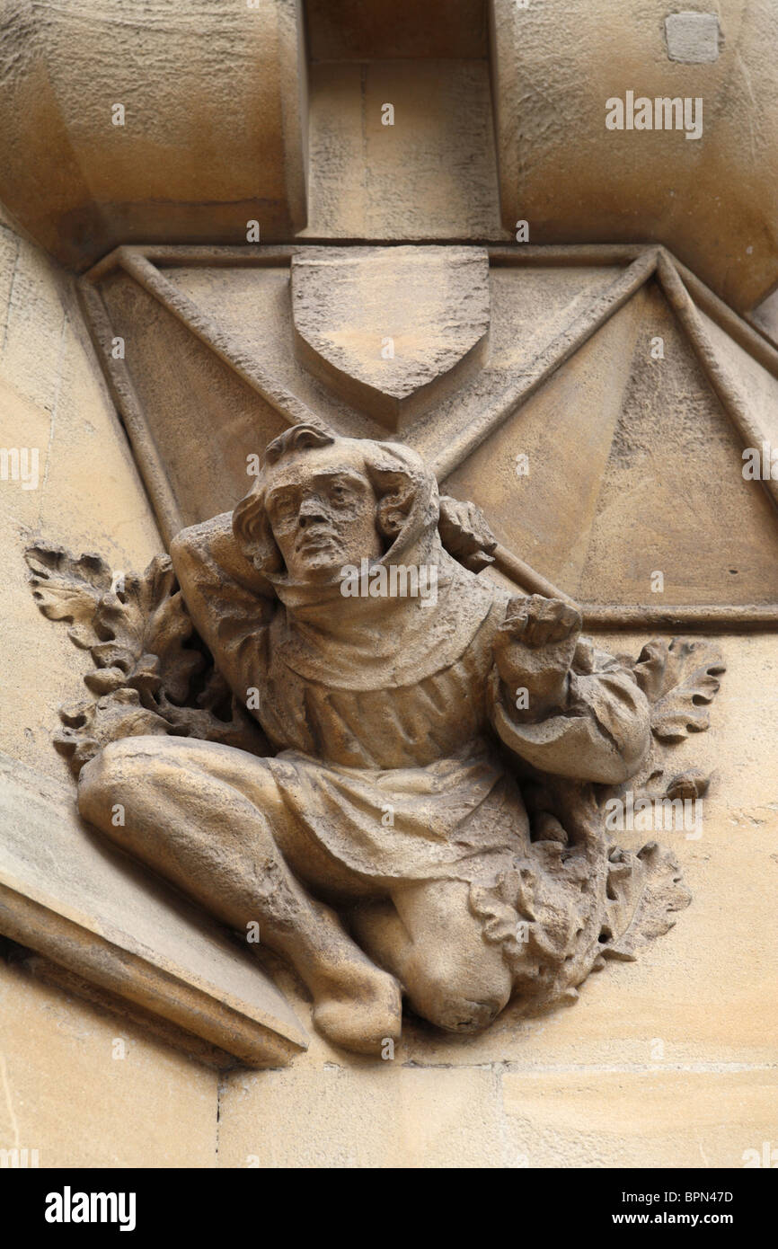 Sculptural corner feature showing the figure of a crouching man in ...