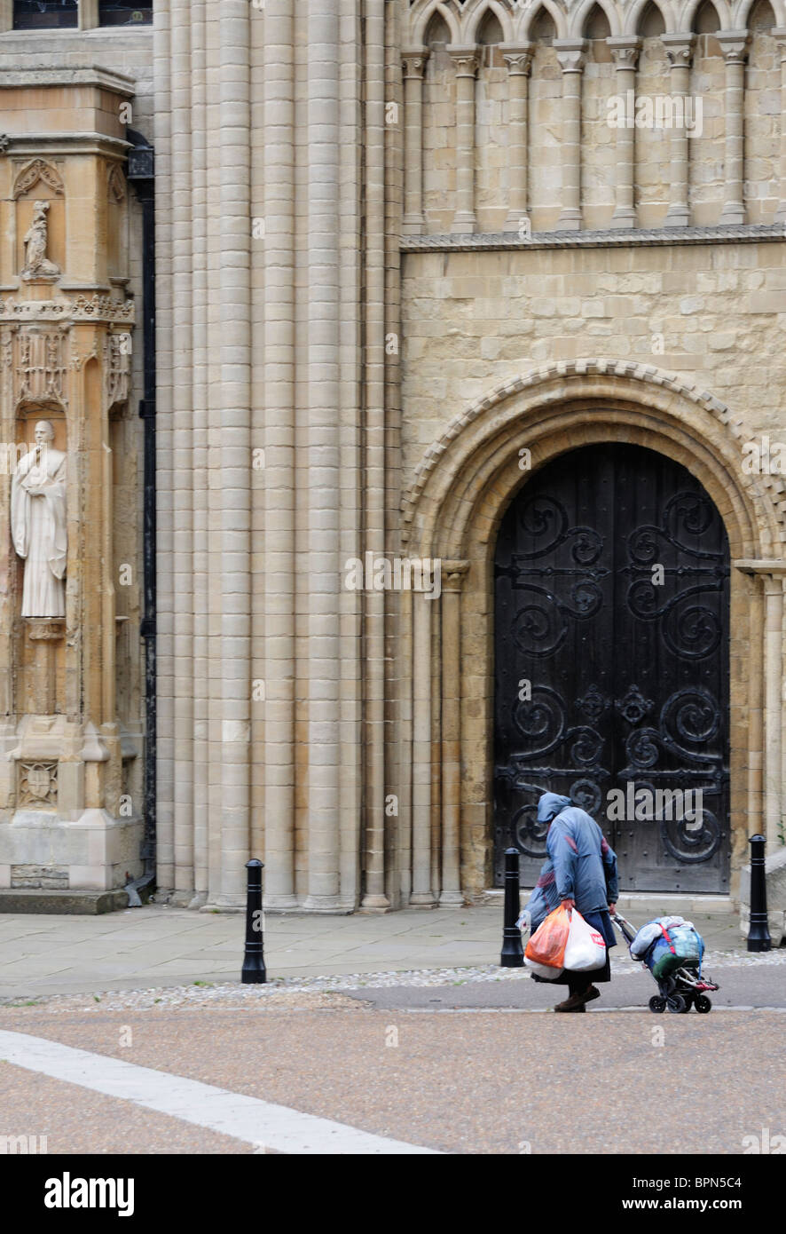 Homeless woman walking past Norwich Cathedral with her belongings Stock ...