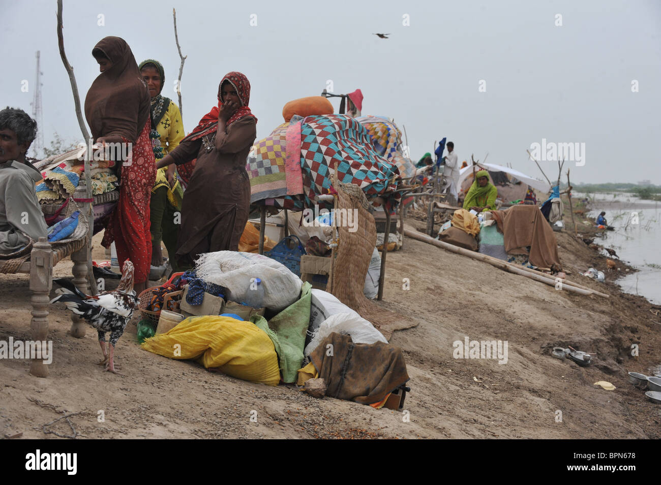 Flood victims living on the only dry areas in Sujawal, Sindh Province ...