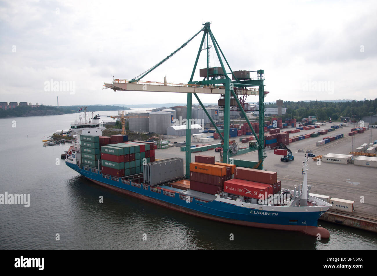 A shipping container being loaded onto a Container ship in the port of ...
