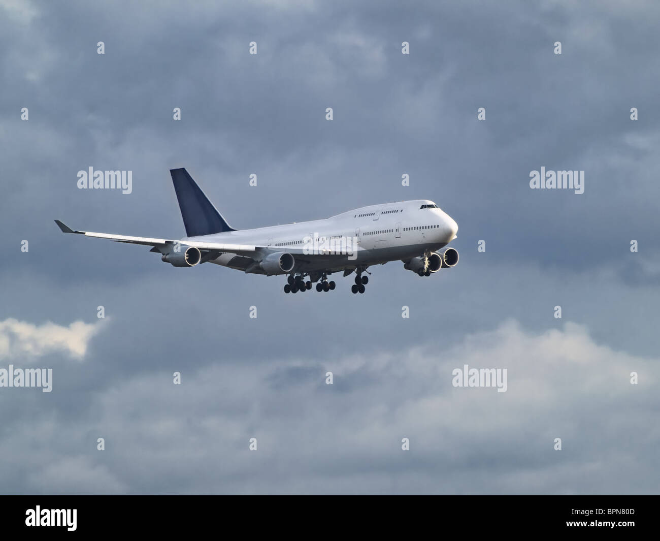 Flying jumbojet aircraft on the final approach in the cloudy weather ...