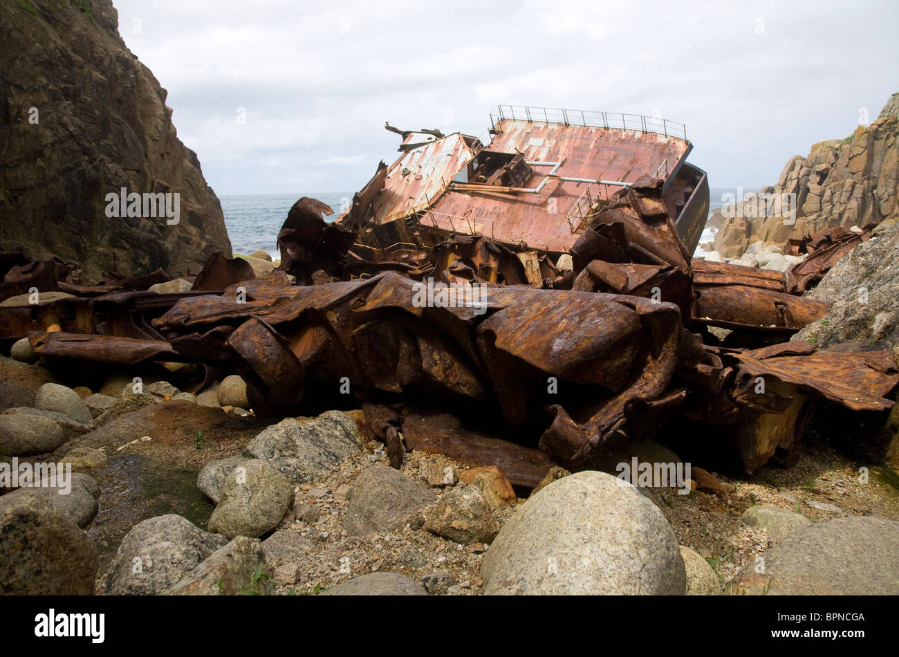 Wreck of a burned ship by the Atlantic Ocean on the rocks Stock Photo ...