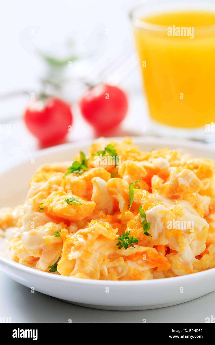 Scrambled eggs and a glass of juice Stock Photo - Alamy