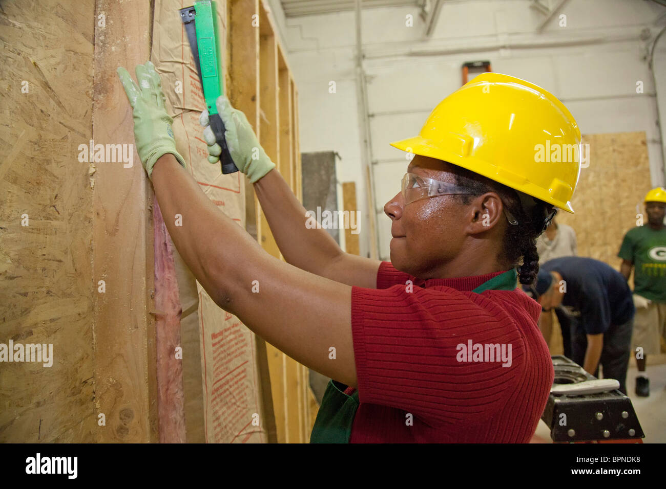 Female worker installing fiberglass hi-res stock photography and images ...