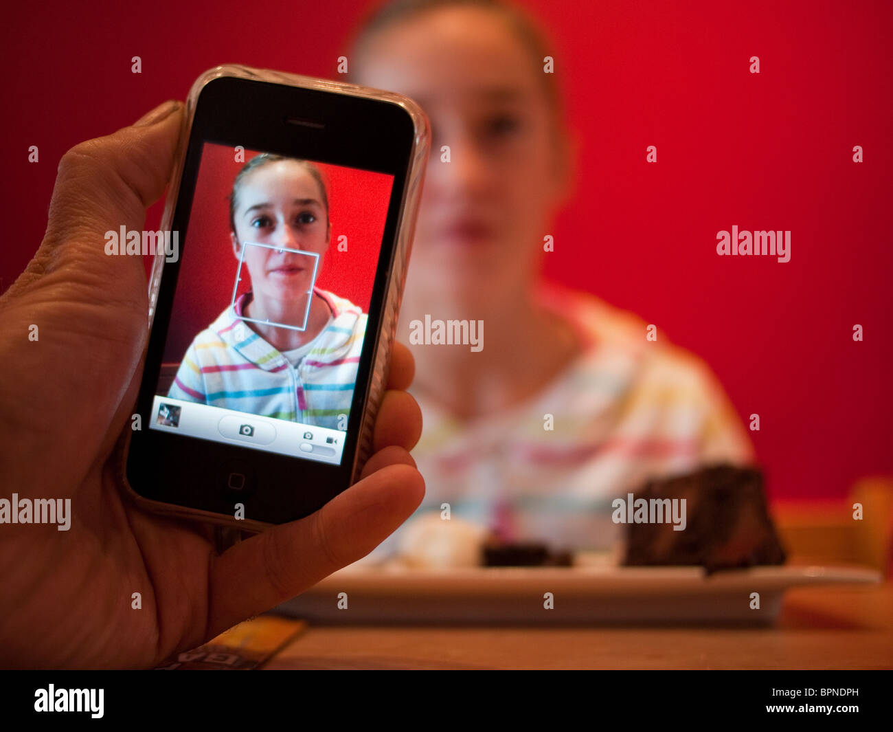 Young Girl on iPhone Screen Stock Photo - Alamy