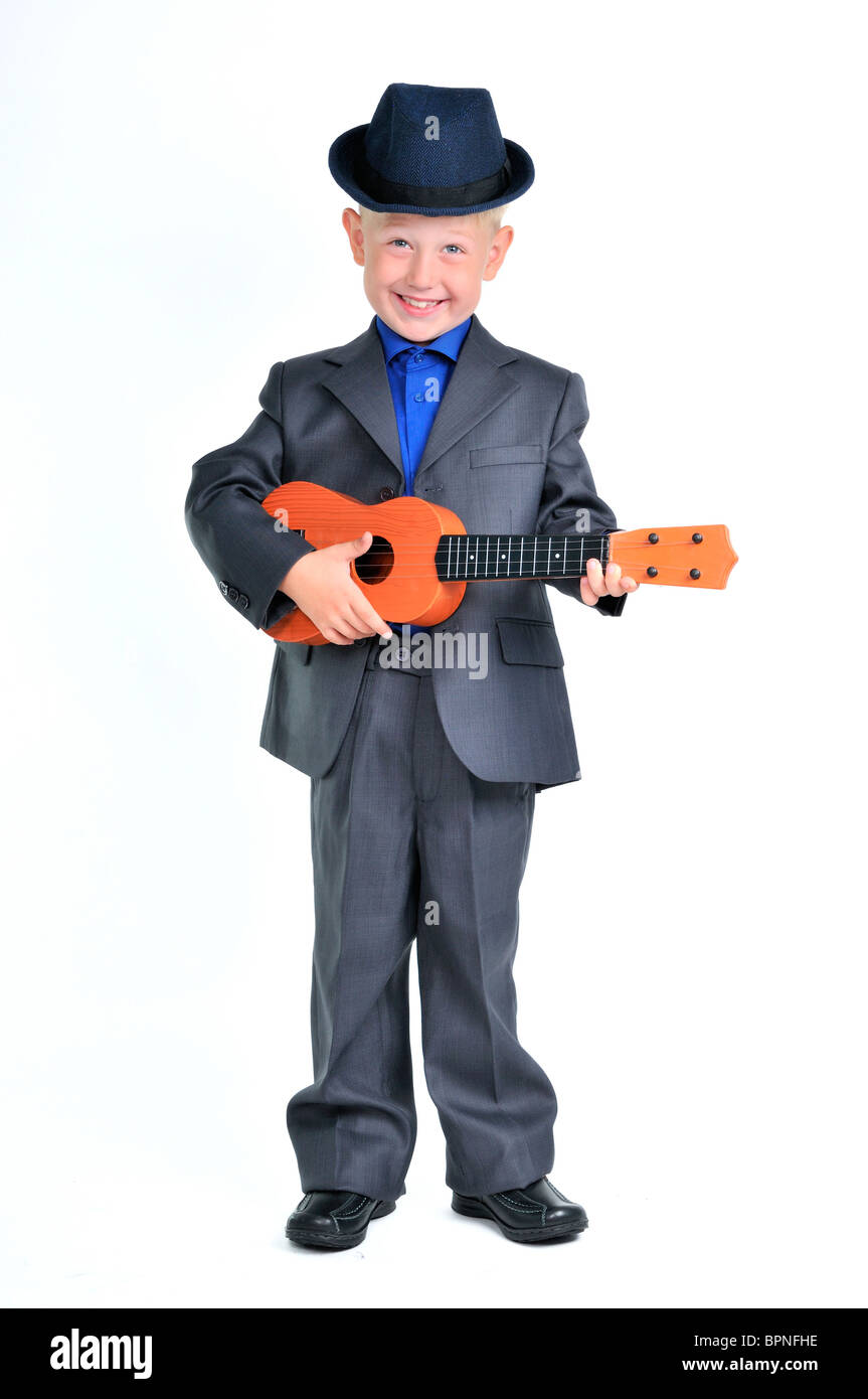 Smart Happy Boy in a Suit playing Guitar Stock Photo - Alamy