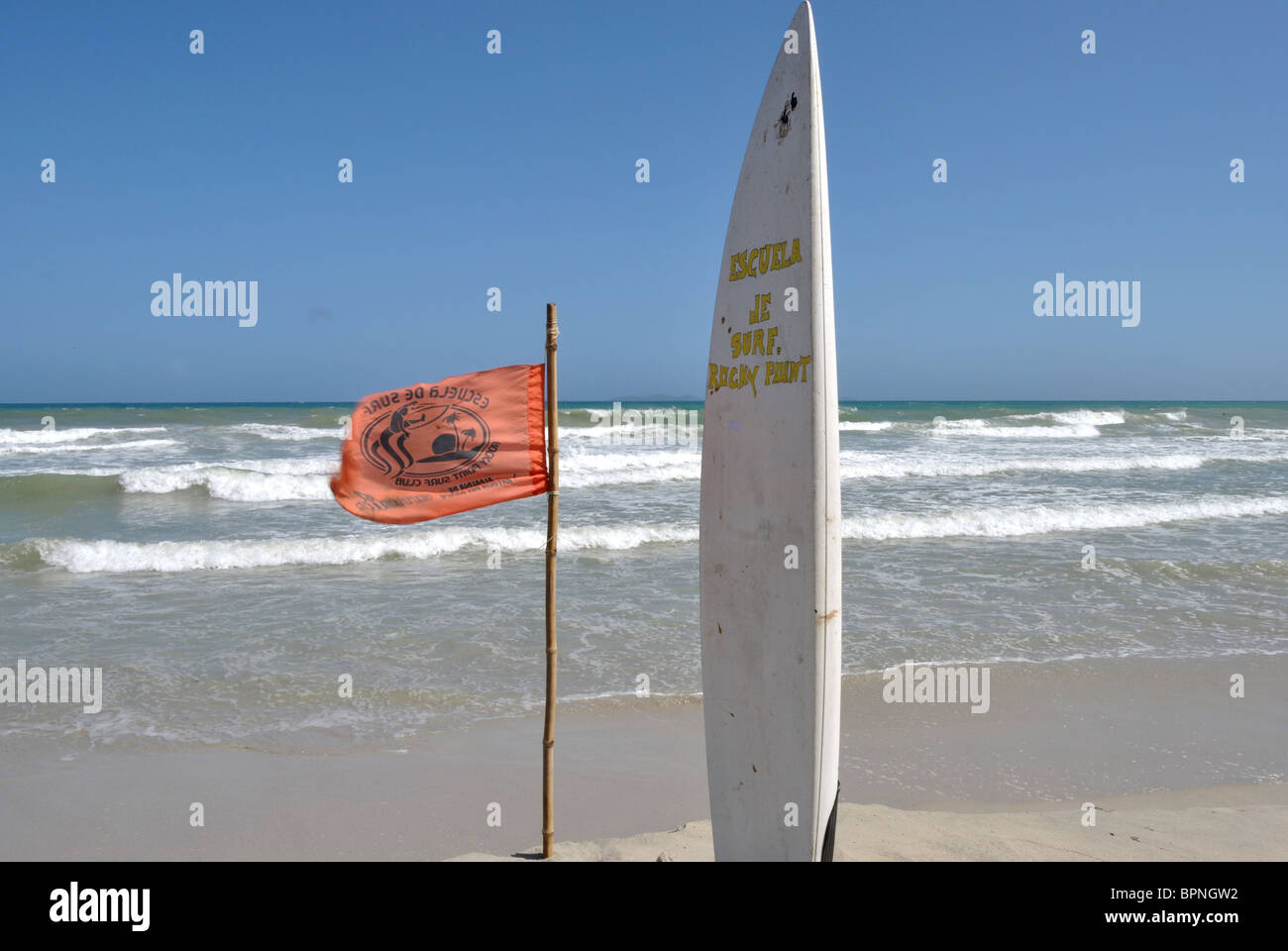 Surfboard and flag located on beach Stock Photo - Alamy