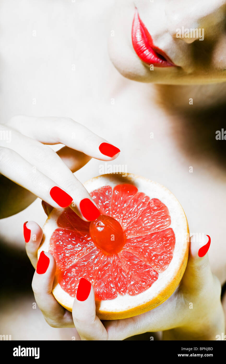 beautiful caucasian woman portrait teasing grapefruit breast concept studio on yellow background ...