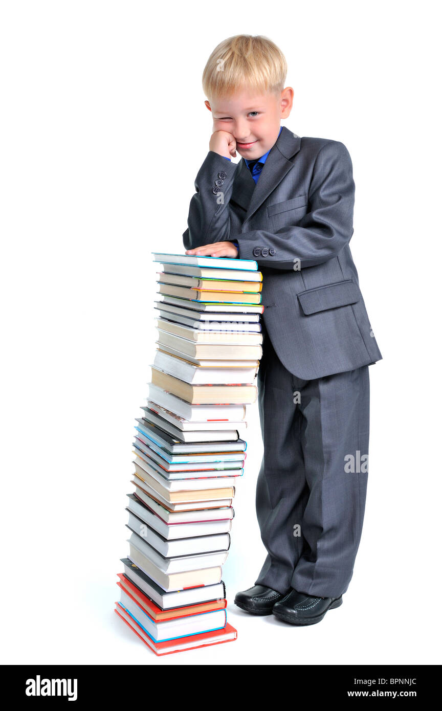 Young Boy leaning over a Pile of Books Stock Photo - Alamy