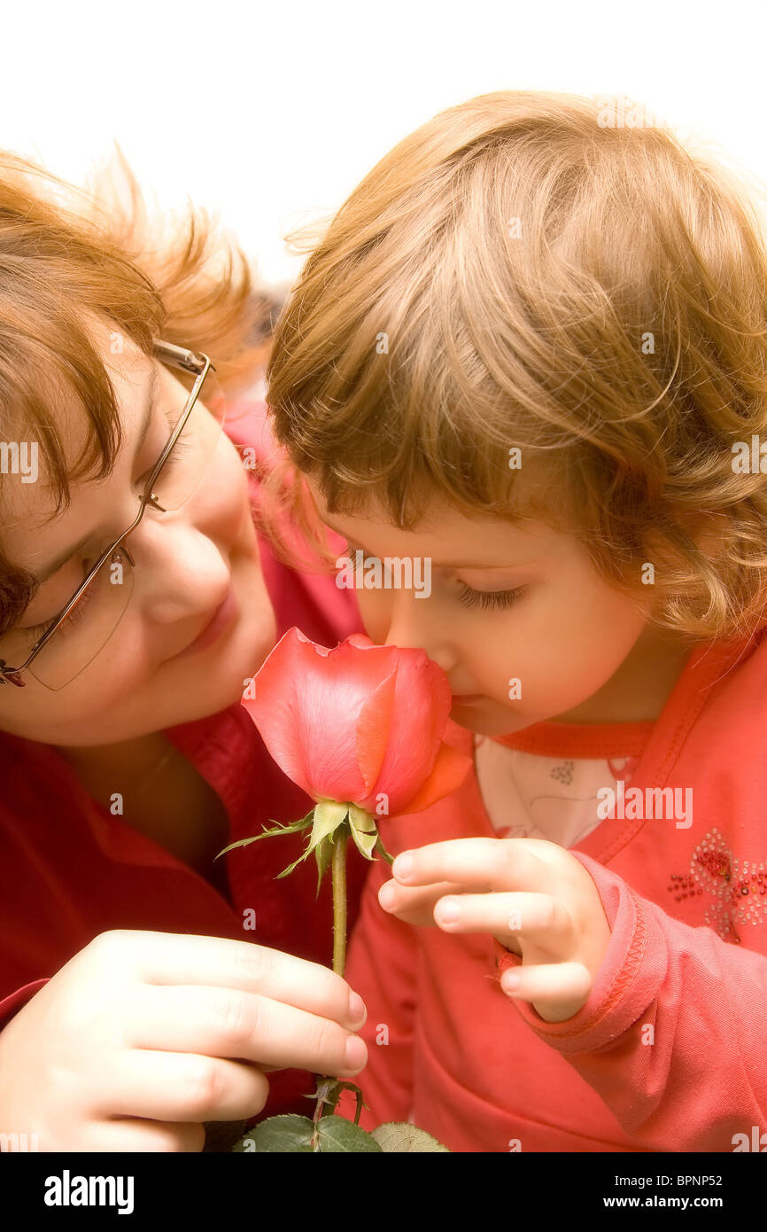 Mother and daughter smelling roses Stock Photo - Alamy