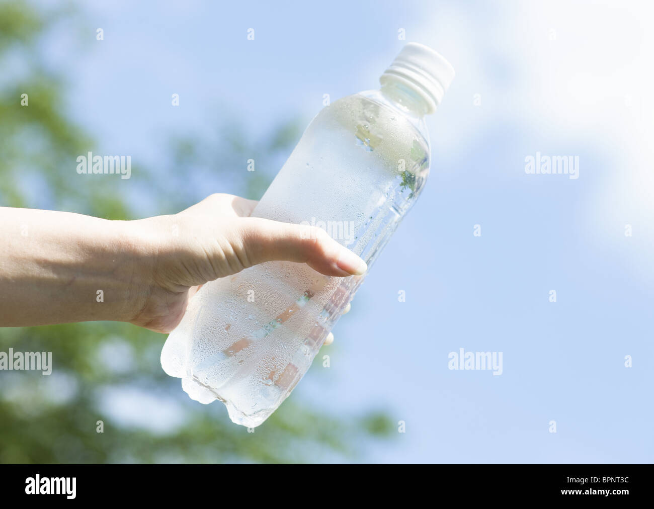 Closeup of hand holding plastic bottle Stock Photo - Alamy