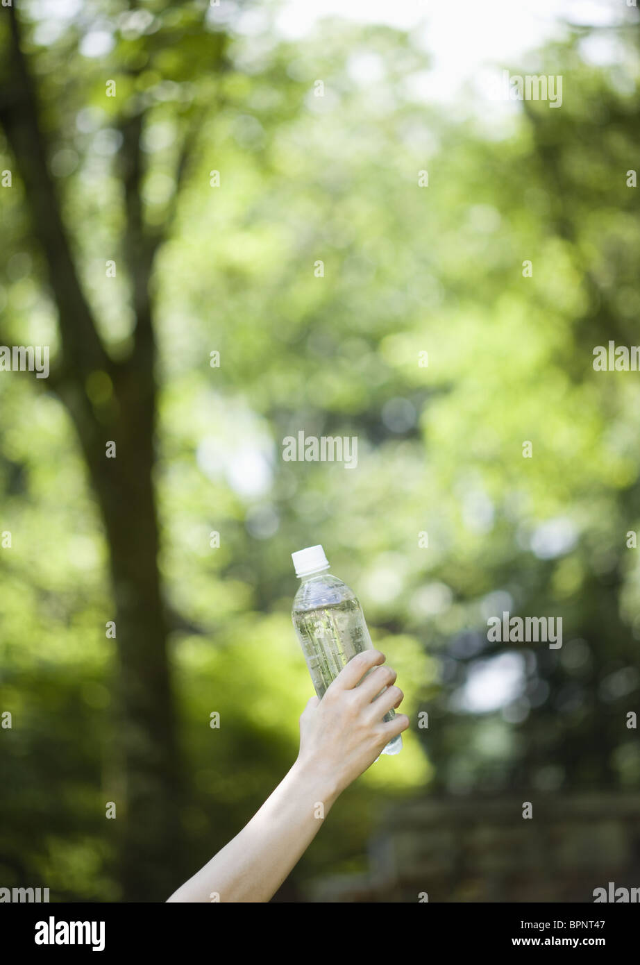 Closeup of hand holding plastic bottle Stock Photo - Alamy