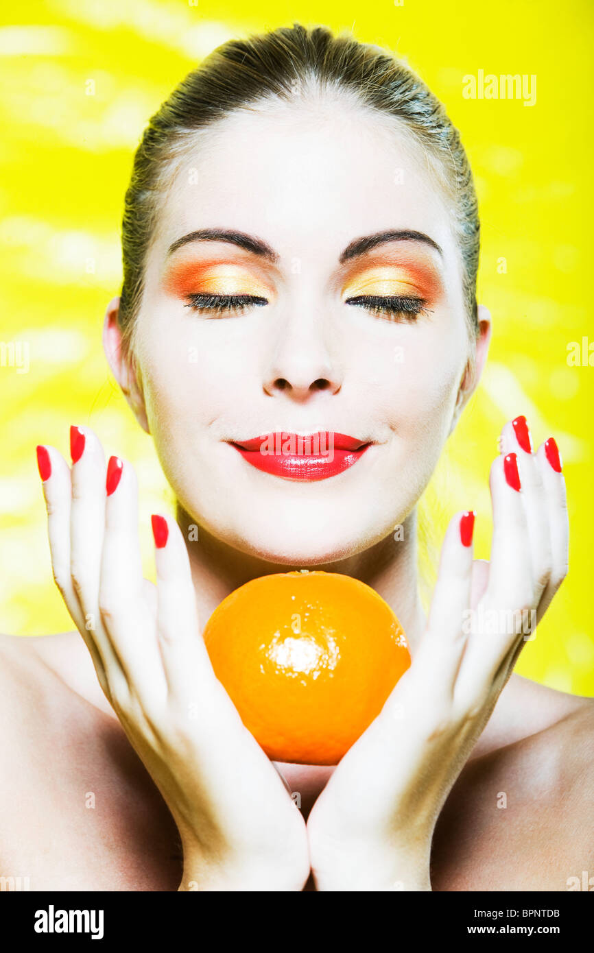 Woman smelling orange fruit hi-res stock photography and images - Alamy