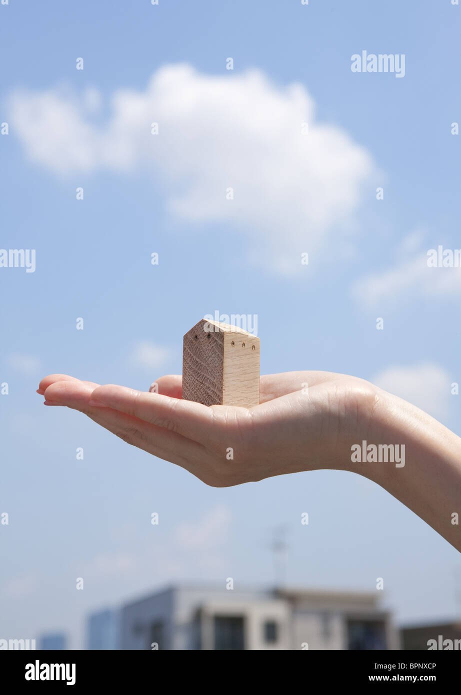 Close up of hand holding miniature house Stock Photo - Alamy