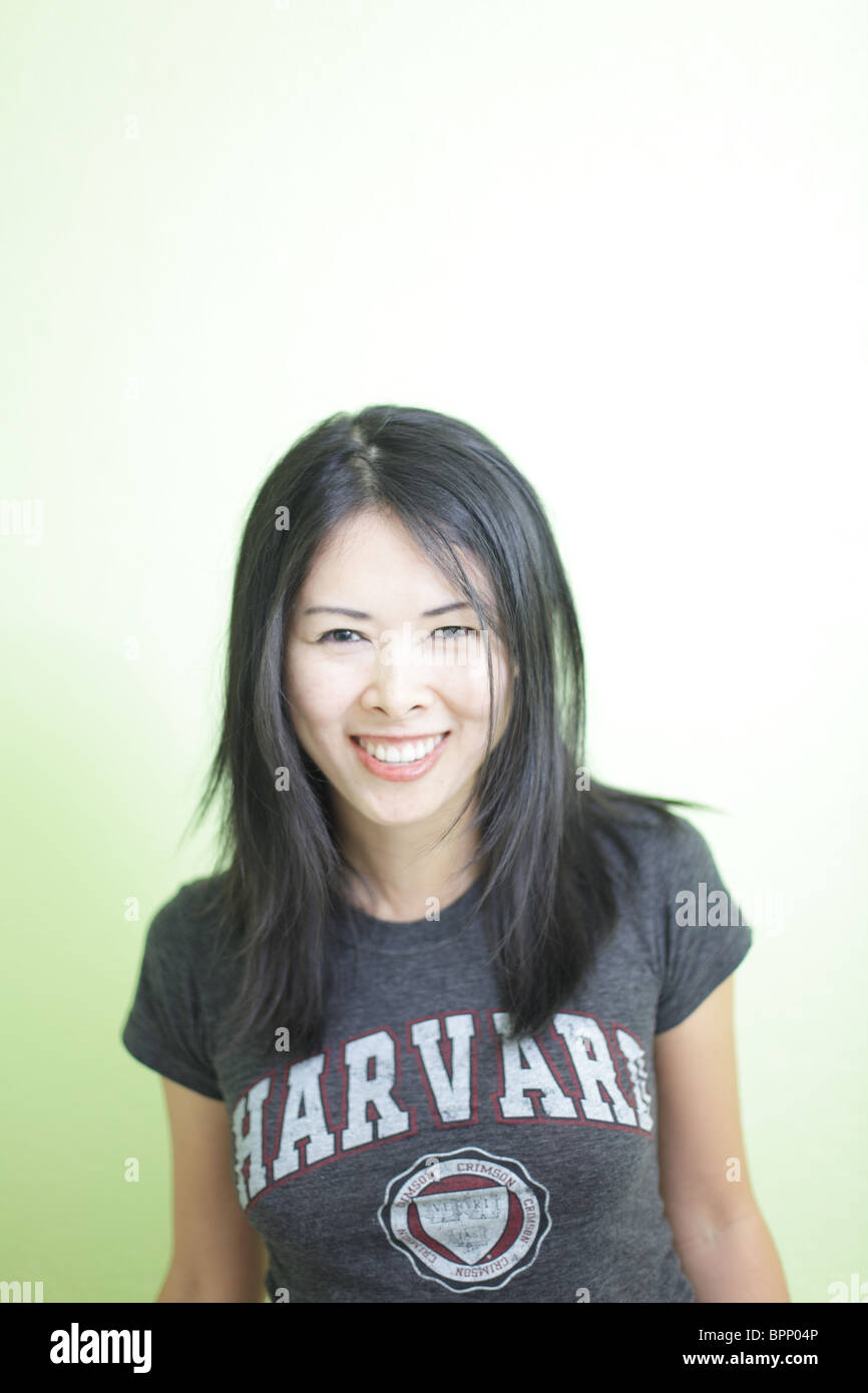 Asian girl wearing Harvard tshirt, Happy Asian girl portrait with green ...