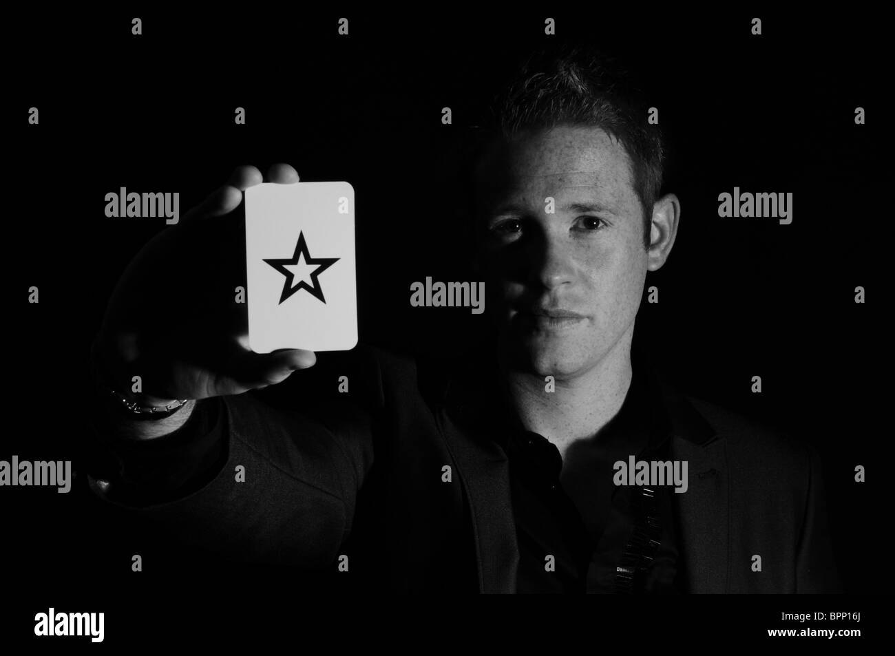 young white male magician in black studio Stock Photo - Alamy