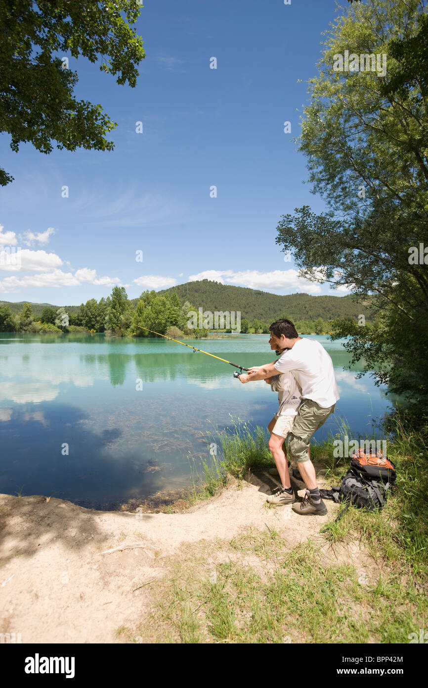 Couple trying to catch a fish Stock Photo - Alamy