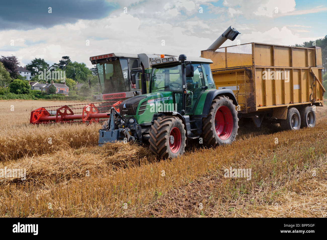 COMBINE HARVESTER LOADING OATS CROP IN TO TRAILER Stock Photo - Alamy