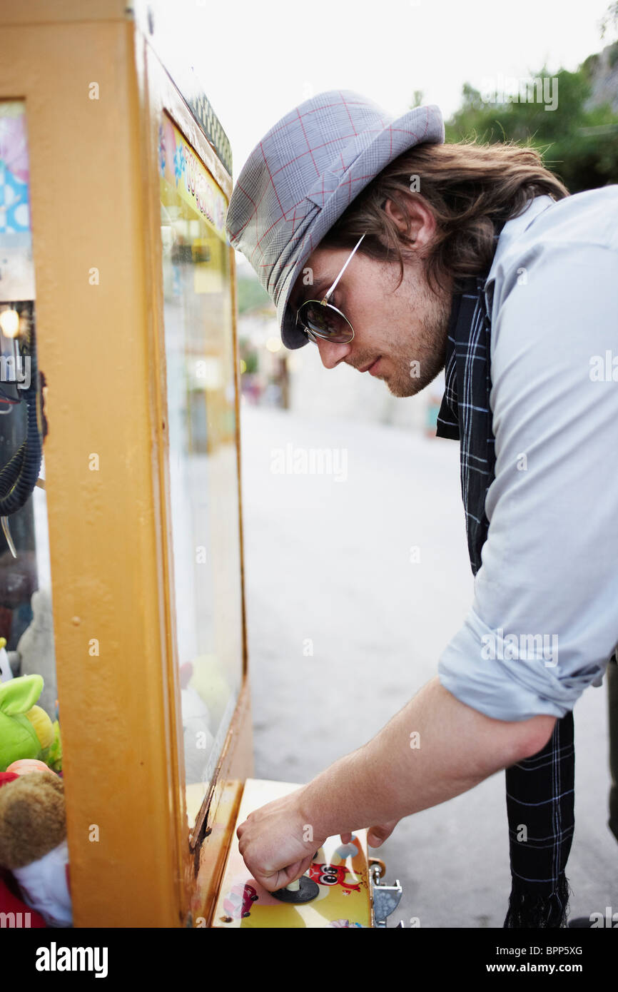 Man playing on arcade cabinet Stock Photo - Alamy
