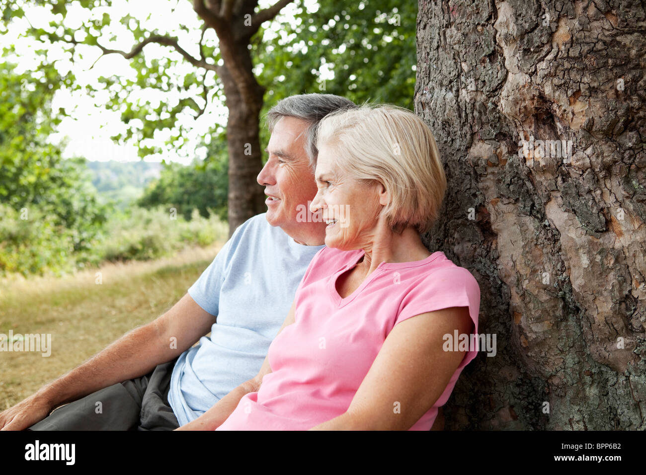 Woman Sitting Against Tree Trunk High Resolution Stock Photography and ...