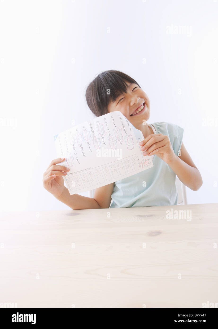 Girl showing her exam paper Stock Photo - Alamy