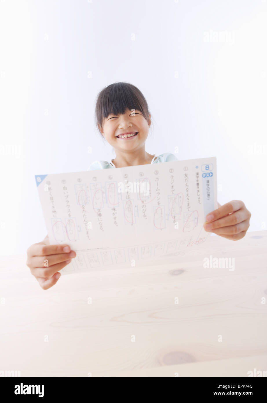 Girl showing her exam paper Stock Photo - Alamy