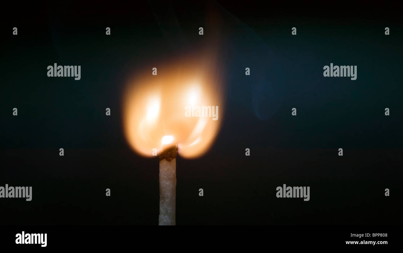 The match is on fire, black background Stock Photo - Alamy