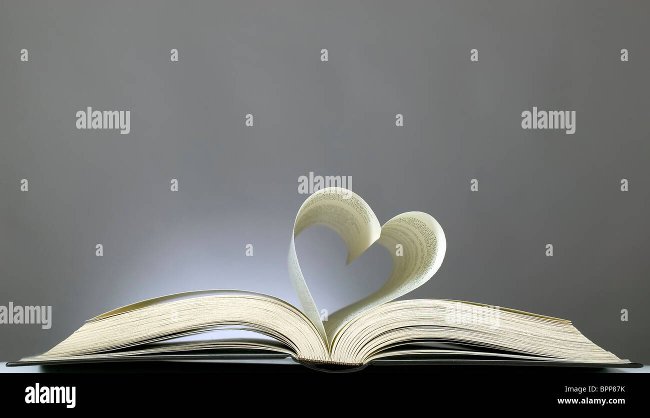 Book with opened pages and shape of heart Stock Photo - Alamy