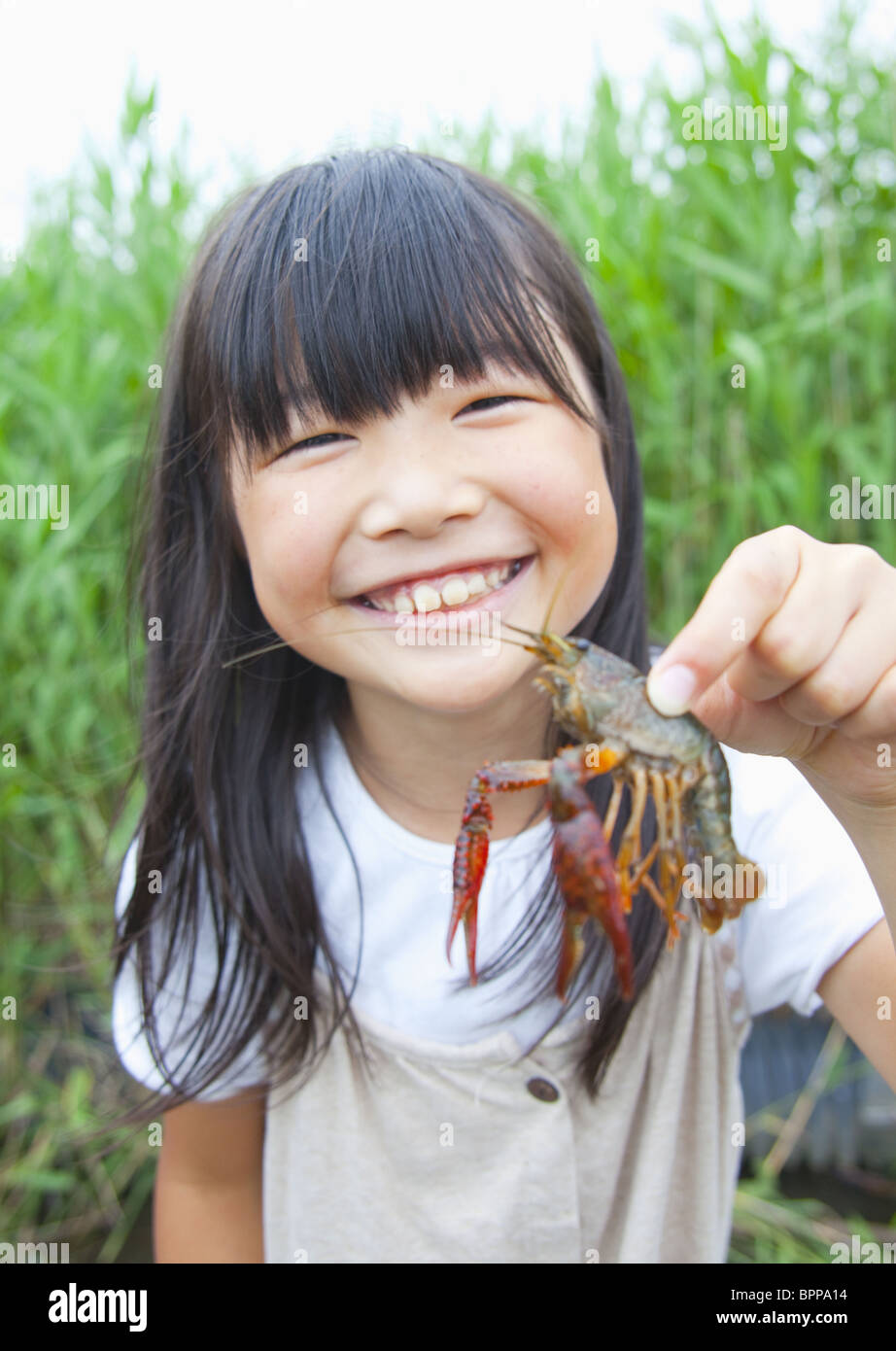 Girl holding a crayfish Stock Photo - Alamy