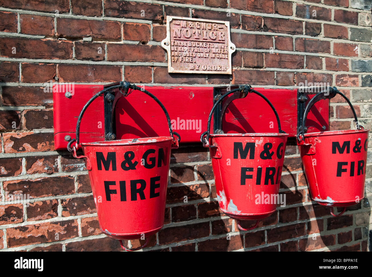 Vintage fire buckets hanging on a wall at Sheringham Station in North ...