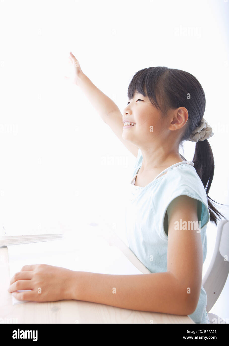 Girl raising her hand Stock Photo - Alamy