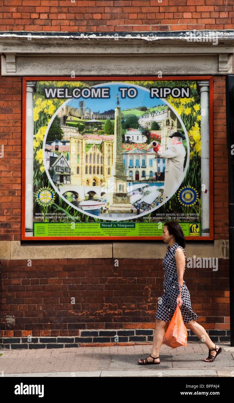 Lady walking past tiled Mosaic in the historic town of Ripon Stock ...