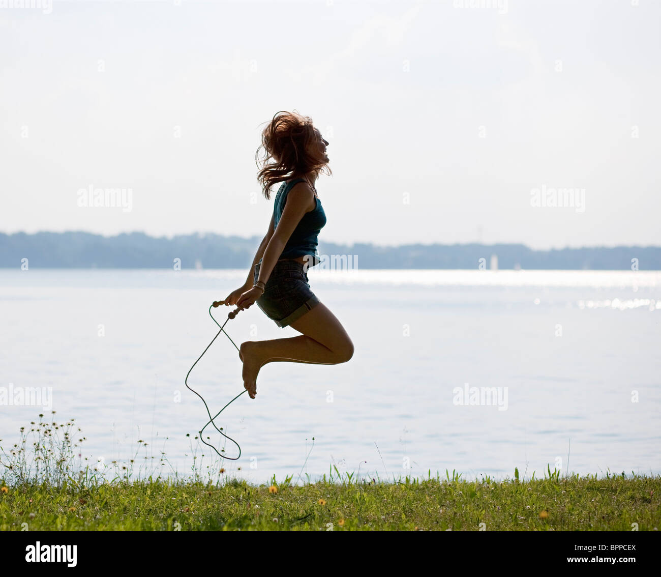 Girl jumping with rope Stock Photo - Alamy