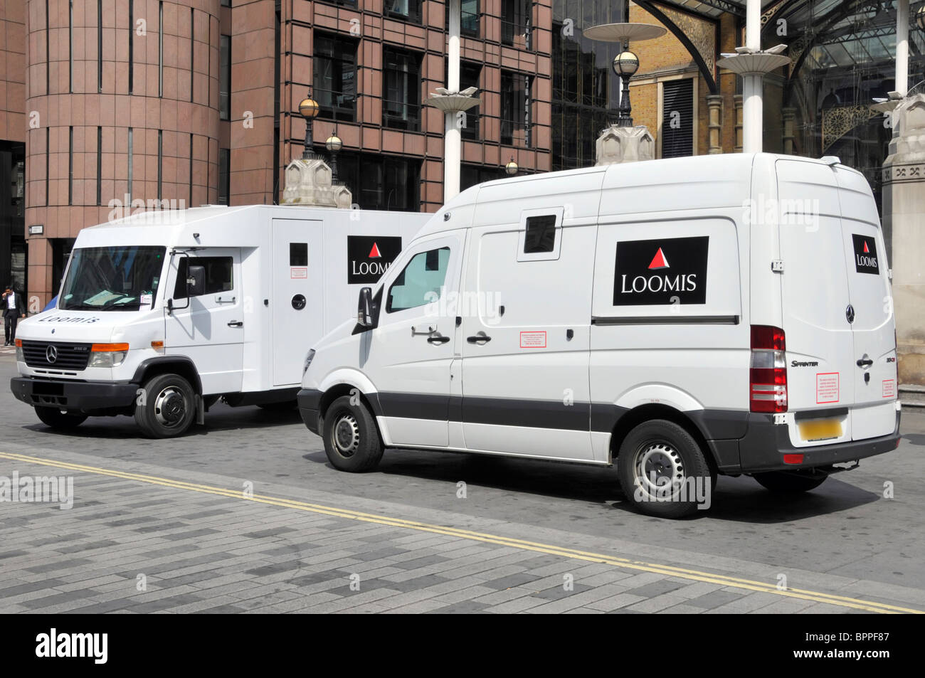 Side and front view of Loomis cash & valuables transport vans a ...