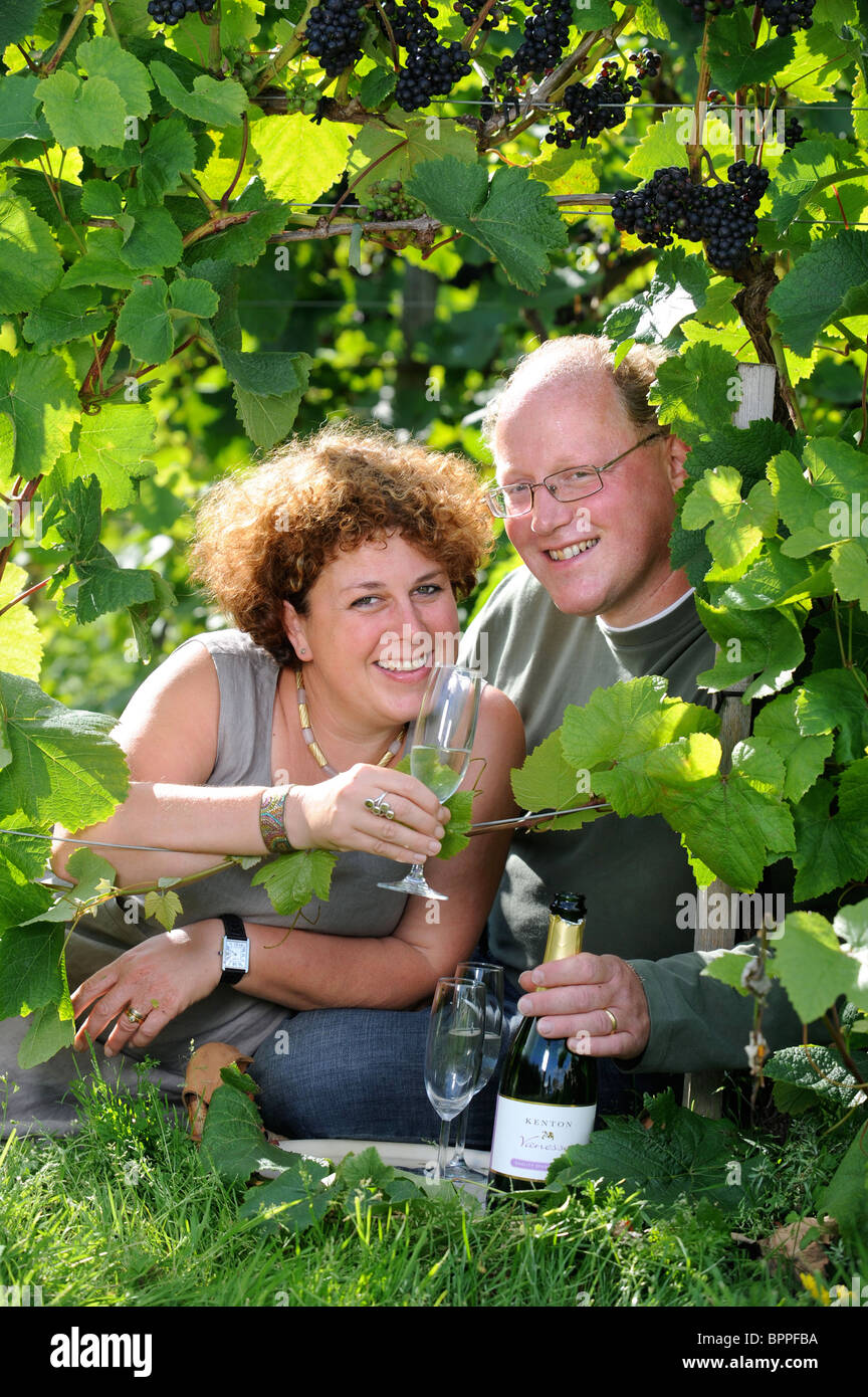 A couple enjoy the produce from their vineyard near Exeter Devon UK ...
