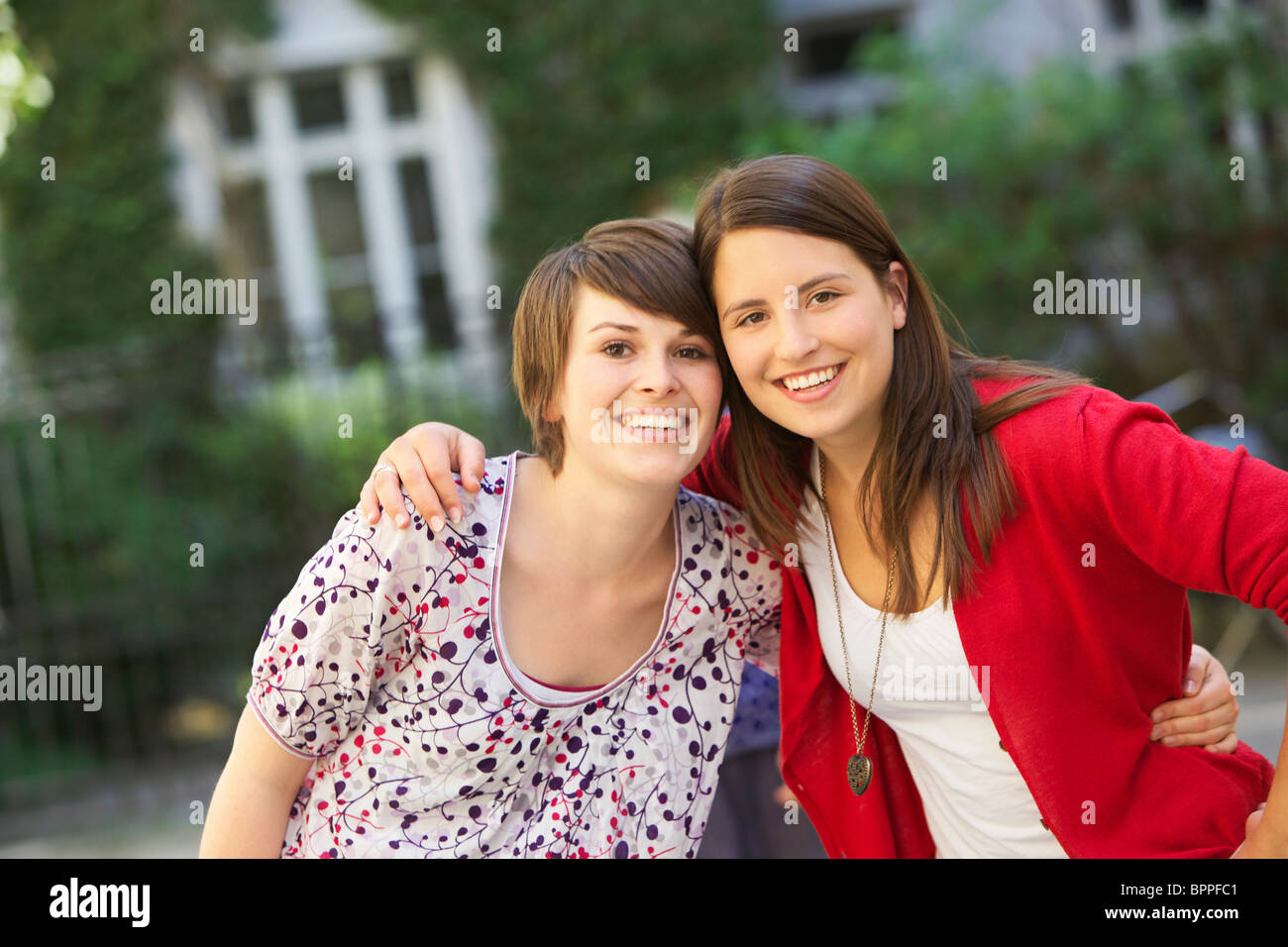 Girls together in a courtyard Stock Photo - Alamy