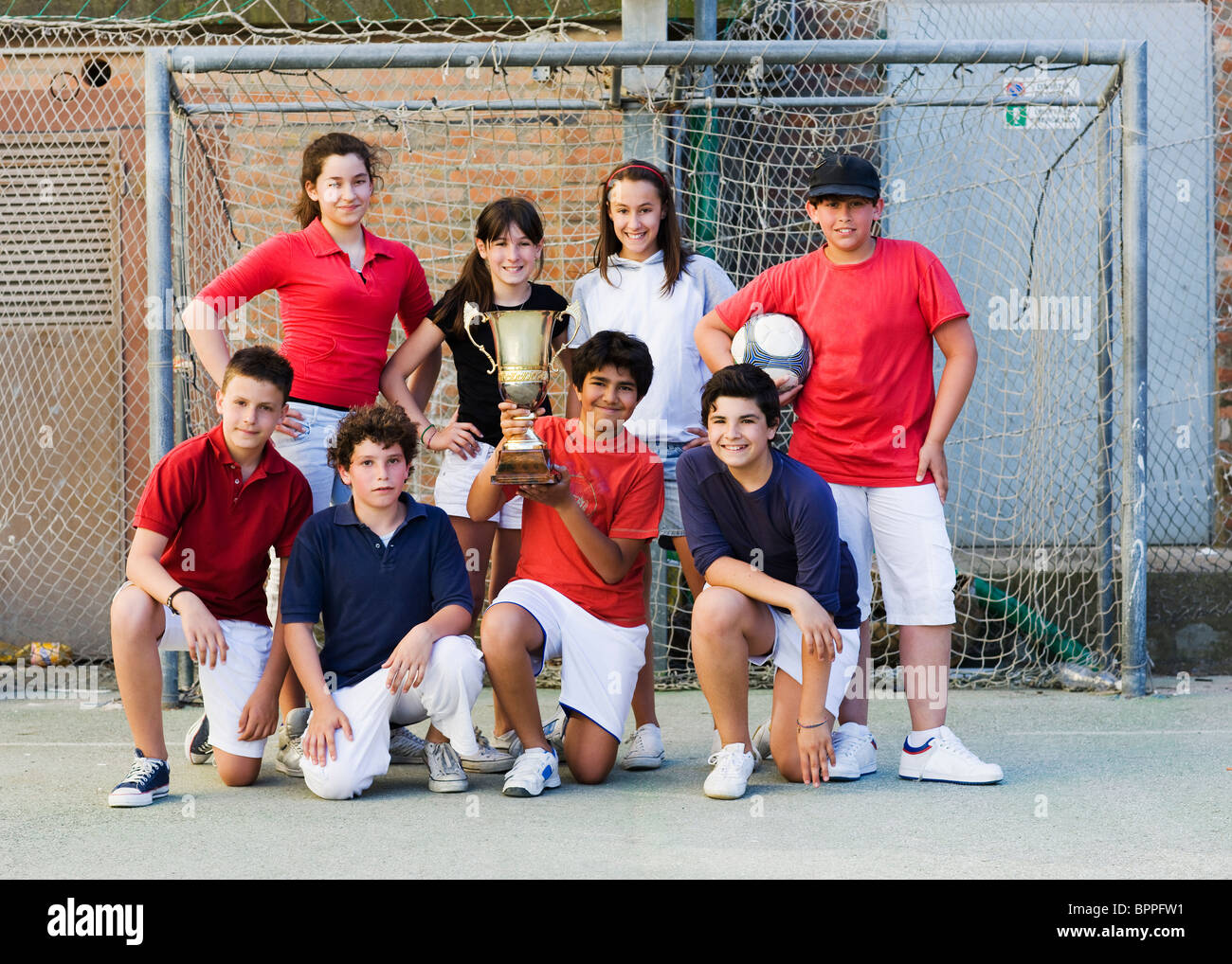 Winning team with a golden cup Stock Photo - Alamy