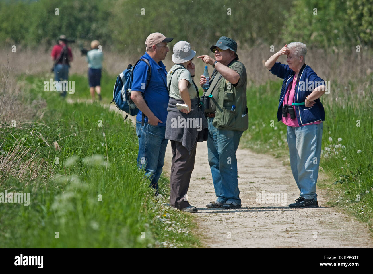 Group of birdwatchers having an intense discussion Stock Photo - Alamy