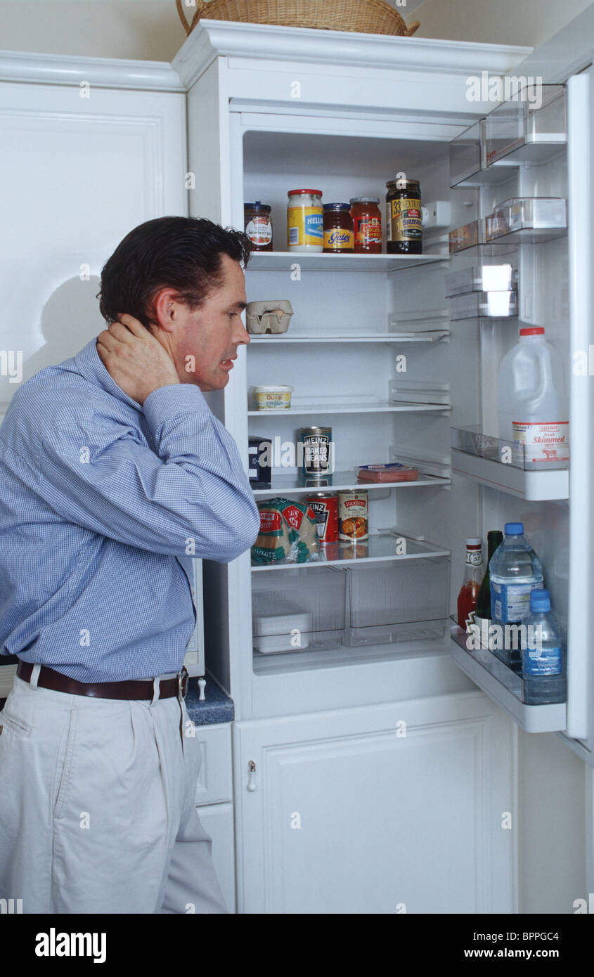 Man young male kitchen looking worried Stock Photo - Alamy