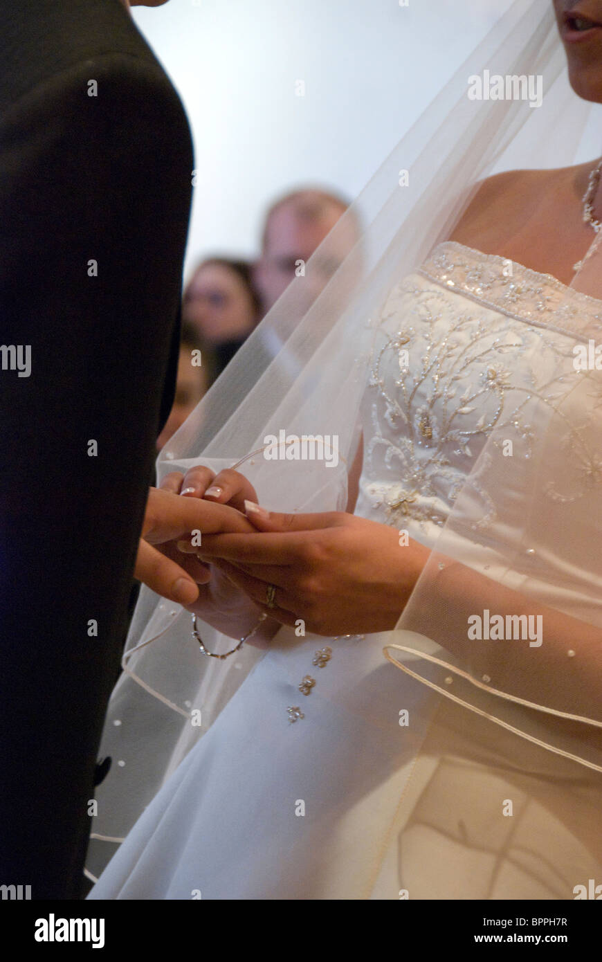 bride putting ring on groom Stock Photo - Alamy