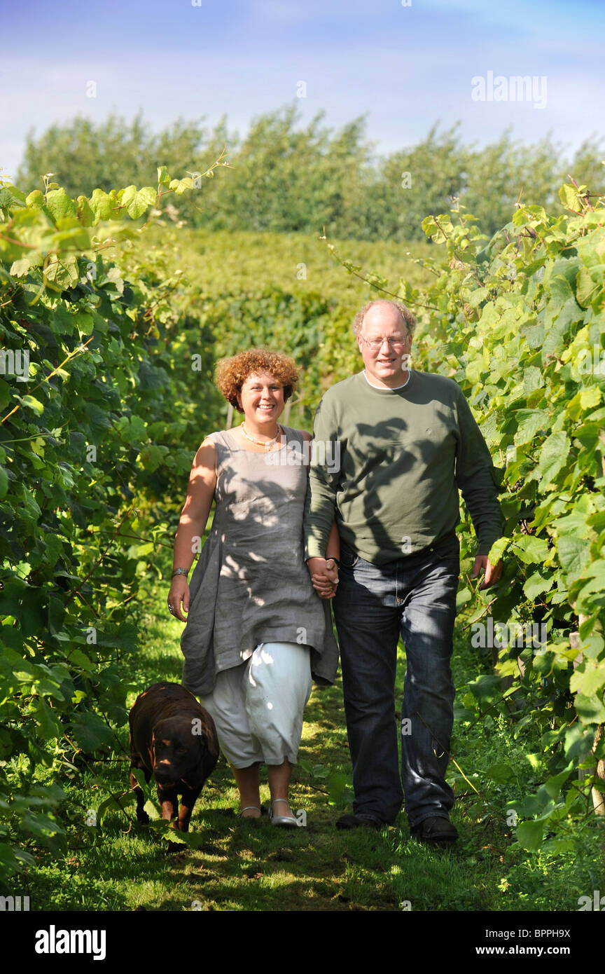 A couple walking in their vineyard near Exeter Devon UK Stock Photo - Alamy
