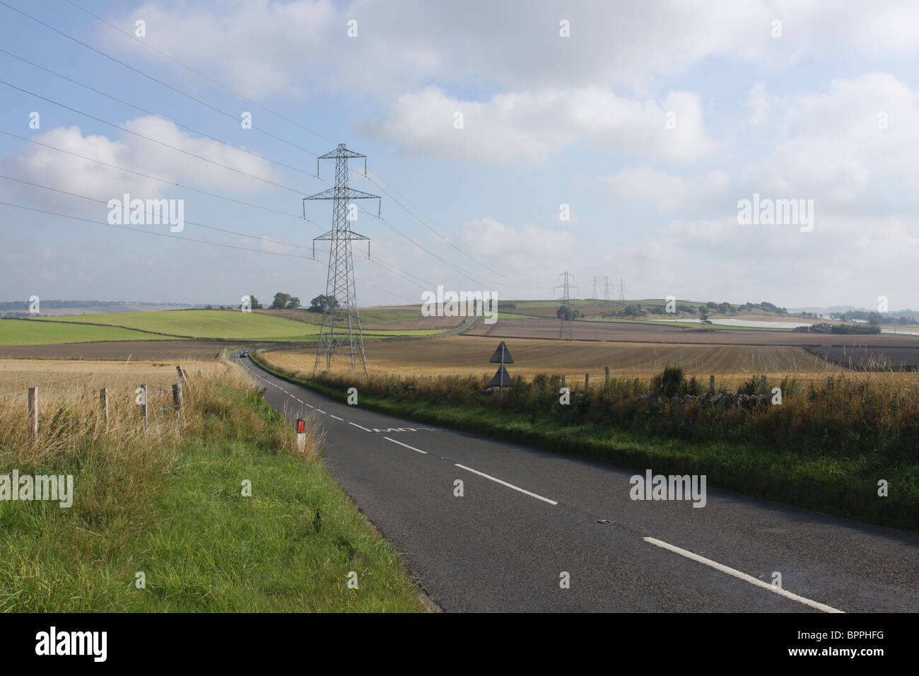country road and electricity pylons near Aberlemno Angus Scotland ...