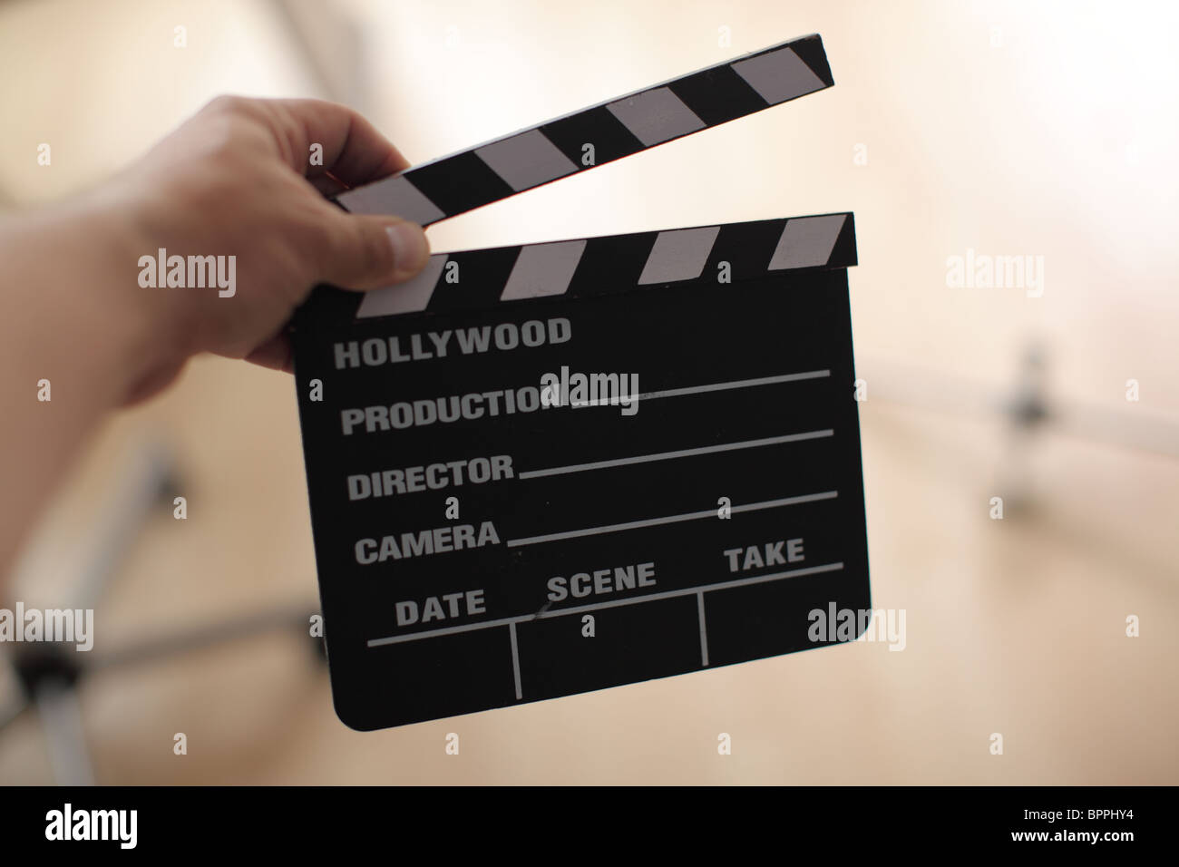 Hand holding movie slate, clapper board Stock Photo - Alamy